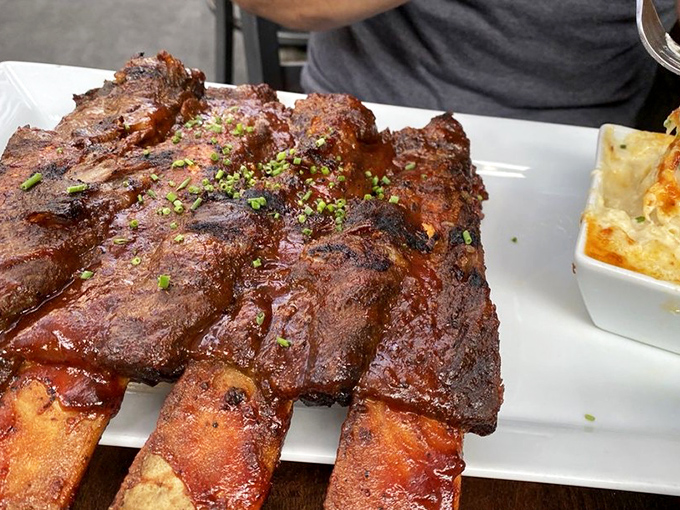 These beef ribs aren't just dinner &ndash; they're prehistoric monuments to carnivorous pleasure, garnished with a sprinkle of fresh herbs.