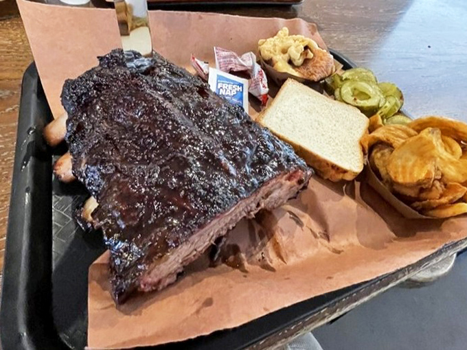 Behold the brisket in its natural habitat—bark so perfect it deserves its own exhibition at the Smithsonian of Smoke.