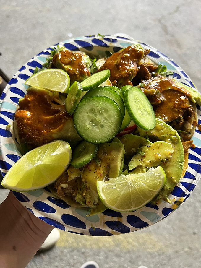 The blue-rimmed plate says "simple," but the taco says "extraordinary." Fresh toppings transform humble street food into culinary poetry.