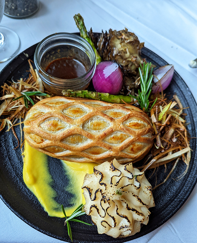 Beef Wellington that's architectural art—a golden pastry cathedral housing perfectly pink tenderloin with mushroom duxelles as the holy sacrament.