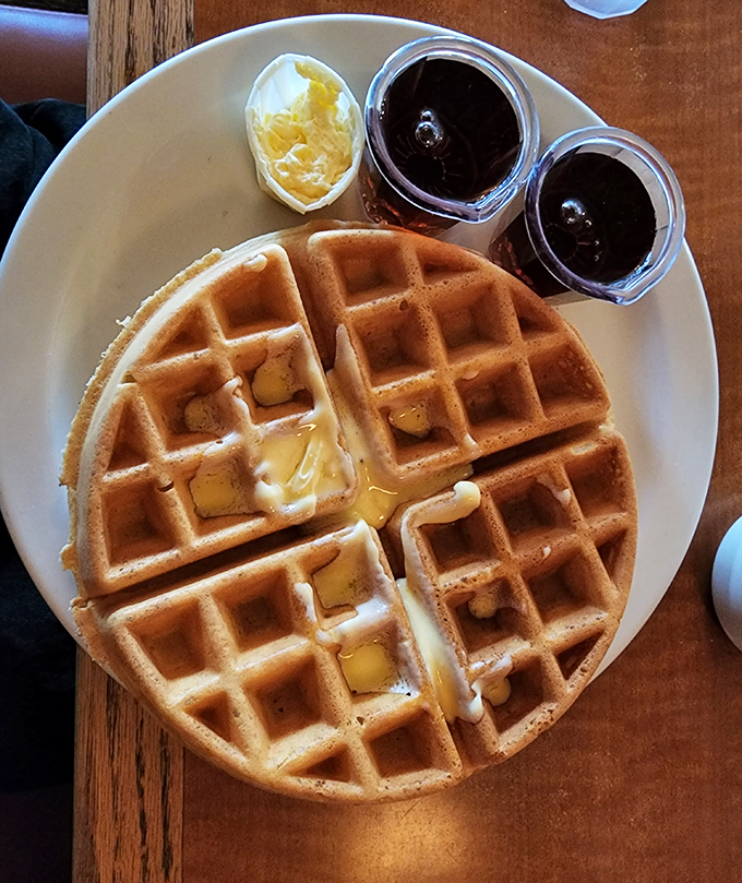 Belgian waffles that achieve the impossible balance&mdash;crisp exterior, fluffy interior&mdash;paired with butter melting into those perfect squares like sunshine into your day.