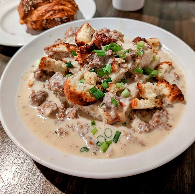 Not your grandmother's biscuits and gravy—unless your grandmother was a culinary genius. This soul-warming dish redefines comfort food for the modern palate.