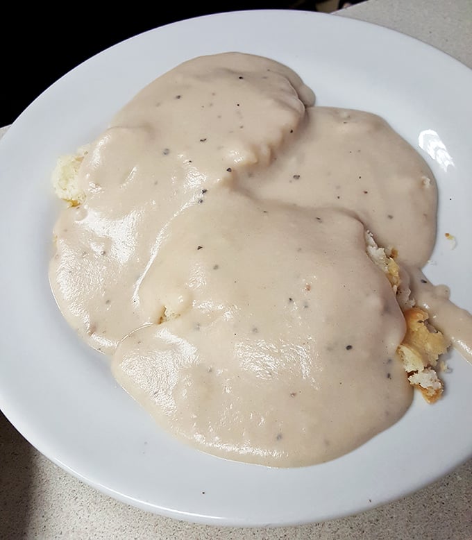 Biscuits drowning in gravy like a delicious Southern baptism on your breakfast plate.