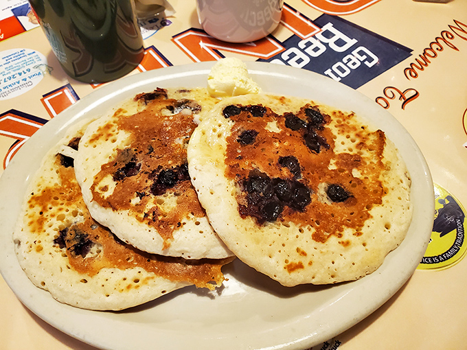 Blueberry pancakes studded with fruit like edible confetti, proving that breakfast can be both indulgent and wholesome.
