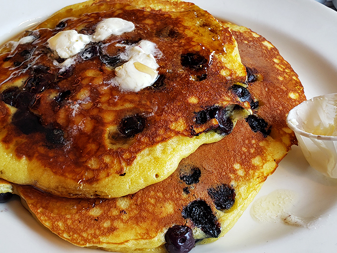 Blueberry pancakes that make you question why you ever bothered with cereal—each berry a tiny burst of sunshine on a cloudy morning.