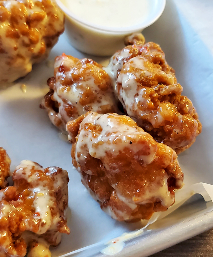 Boneless wings glistening with sauce that walks the perfect line between sweet and heat&mdash;each bite a reminder of why napkins were invented.