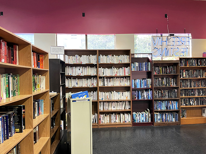A bibliophile's dream corner where literary treasures are arranged by color, creating a bookshelf worthy of Instagram fame.