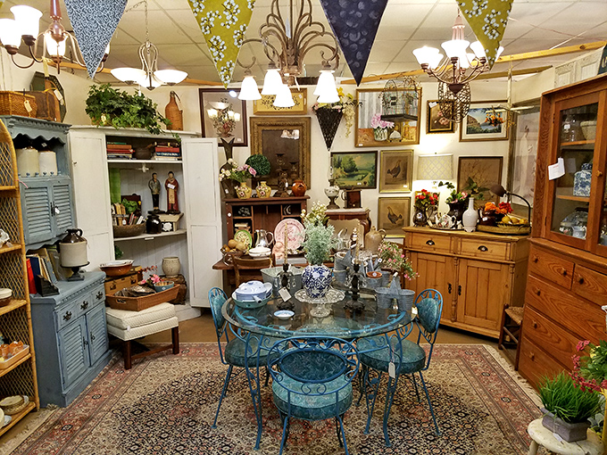 Colorful fabric pennants add whimsy above a carefully curated booth where every item tells a story. That blue dining set practically screams "Mediterranean al fresco!"