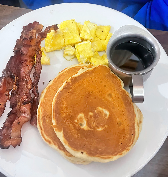 The breakfast trifecta &ndash; perfectly cooked bacon, golden pancakes, and scrambled eggs that would make your grandmother nod in approval.