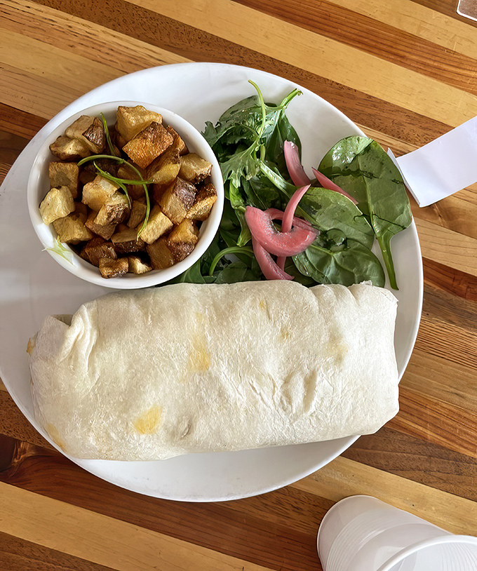 This burrito wraps morning happiness in a soft tortilla with crispy potatoes as sidekicks.