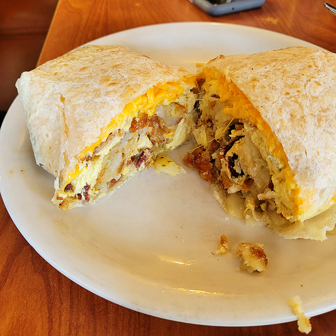 When a breakfast burrito is cut in half like this, it's not just food &ndash; it's a cross-section of morning joy, revealing treasure layers within.