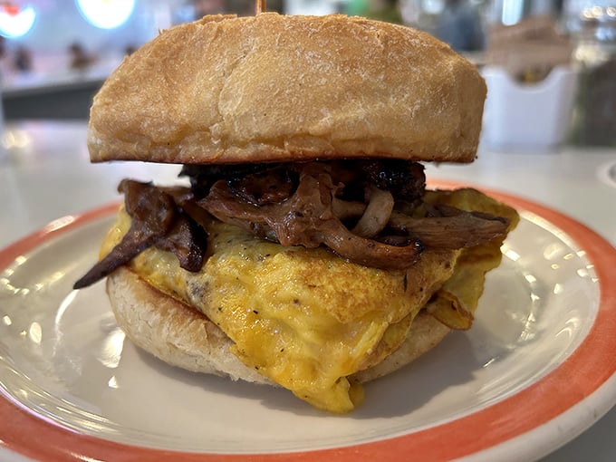 Breakfast sandwich perfection: a golden egg blanket wrapped around melty cheese and savory meat on a pillow-soft bun. Morning has officially improved.