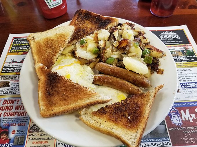 Perfectly browned breakfast sausage links alongside golden toast and home fries&mdash;proof that sometimes the simplest breakfast combinations are the most satisfying.