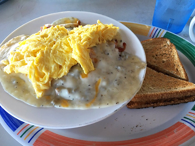 Breakfast alchemy: Fluffy scrambled eggs floating atop a sea of creamy sausage gravy. Your diet plan just called&mdash;it's taking the day off.