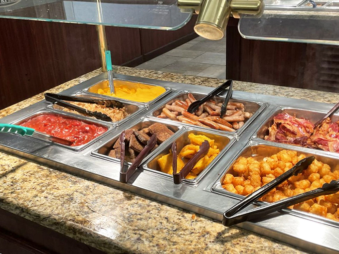 The breakfast buffet spread in all its morning glory&mdash;where sausages, eggs, and golden-fried offerings line up like delicious soldiers ready for duty.