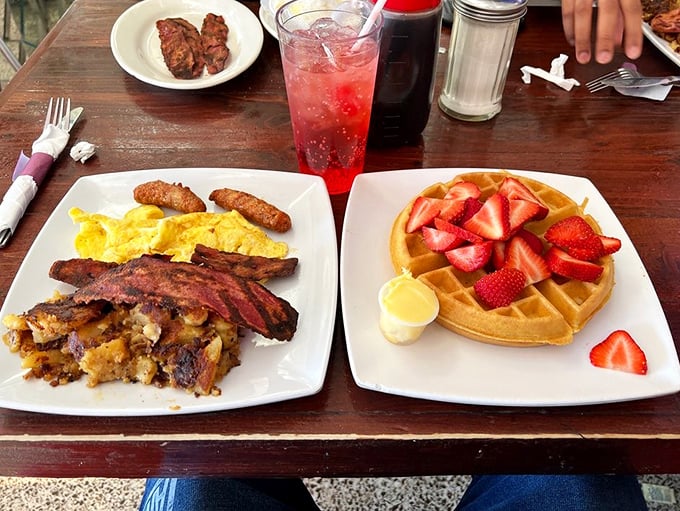 Breakfast perfection on a plate: golden waffles with strawberries alongside eggs and bacon&mdash;the breakfast equivalent of having both Netflix AND HBO Max.