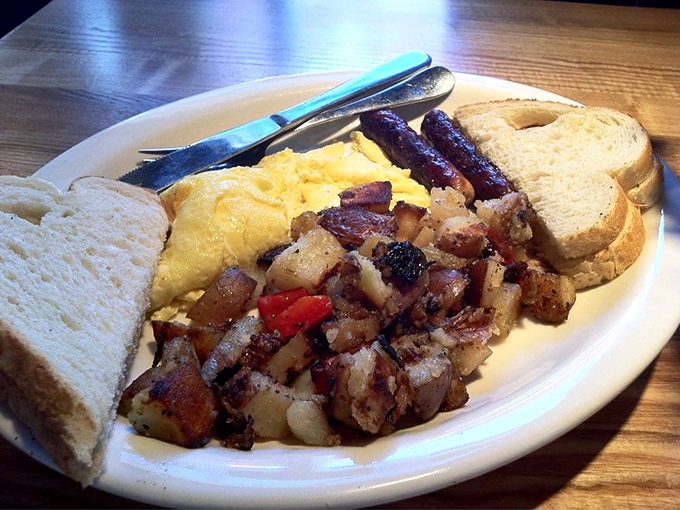 The breakfast trinity: fluffy eggs, crispy potatoes, and perfectly toasted bread. A plate that says "good morning" in the most delicious language.
