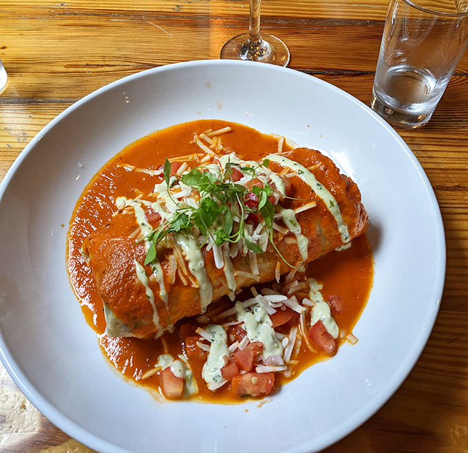 This burrito isn't just wrapped, it's embraced by its tortilla, swimming in a sauce so good you'll want to write it a thank-you note.