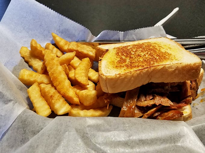 Pulled meat piled high on Texas toast with crispy fries—the kind of lunch that requires a nap.