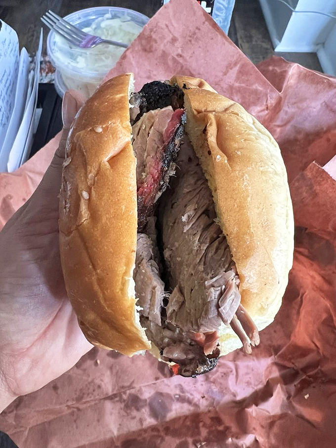 This sandwich isn't messing around &ndash; the brisket is practically spilling out like it's trying to make a break for it before you can devour it.