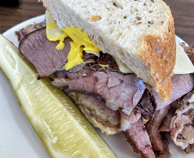 Brisket so tender it practically surrenders at the sight of your fork, nestled between bread that knows its supporting role.