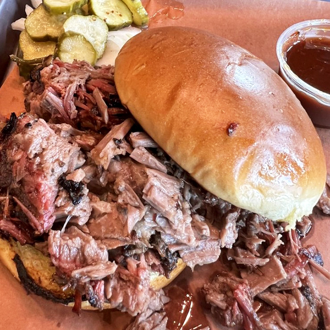 The sandwich that launched a thousand napkins &ndash; tender brisket spilling from its bun like it's making a jailbreak toward your taste buds.