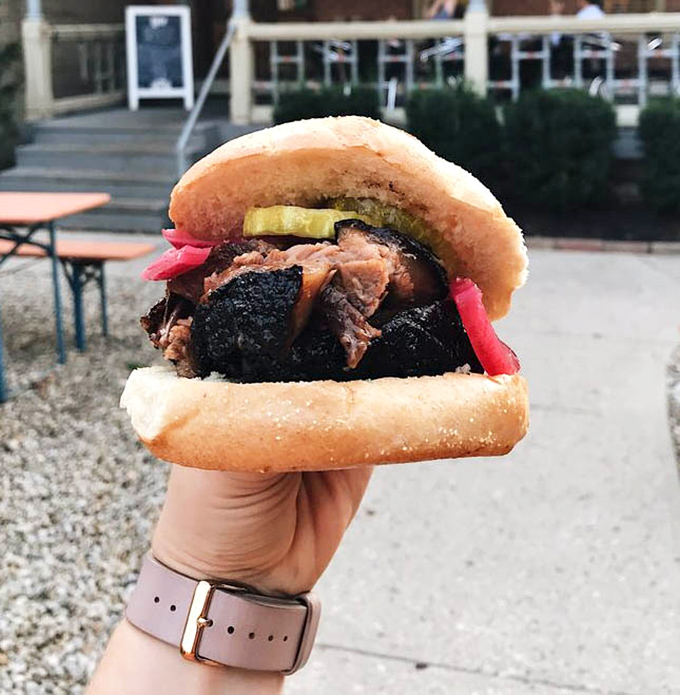 A brisket sandwich accessorized with pickles and onions &ndash; like a little black dress that's been perfectly accessorized for the meat prom.
