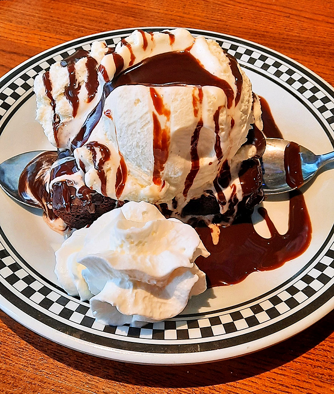 This brownie sundae isn't just dessert—it's therapy on a plate. Warm chocolate, cold ice cream, and whipped cream creating the holy trinity of sweet satisfaction.