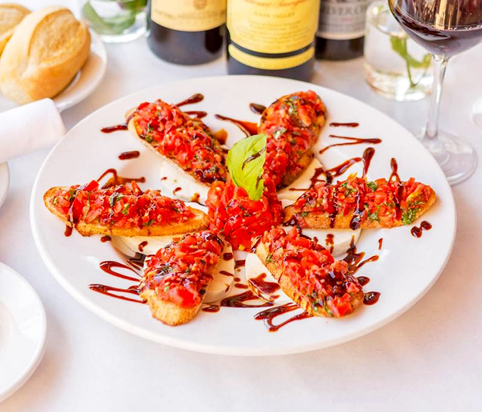 Bruschetta arranged like a sunburst &ndash; each piece a crunchy canvas for the summer-sweet tomatoes and balsamic drizzle that makes you want to lick the plate.