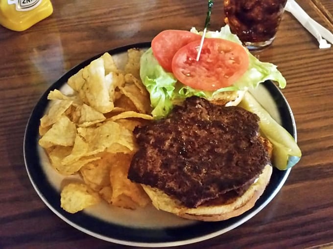 A burger that means business, nestled alongside chips that didn't dare come from a bag. This is road trip fuel of the highest order.