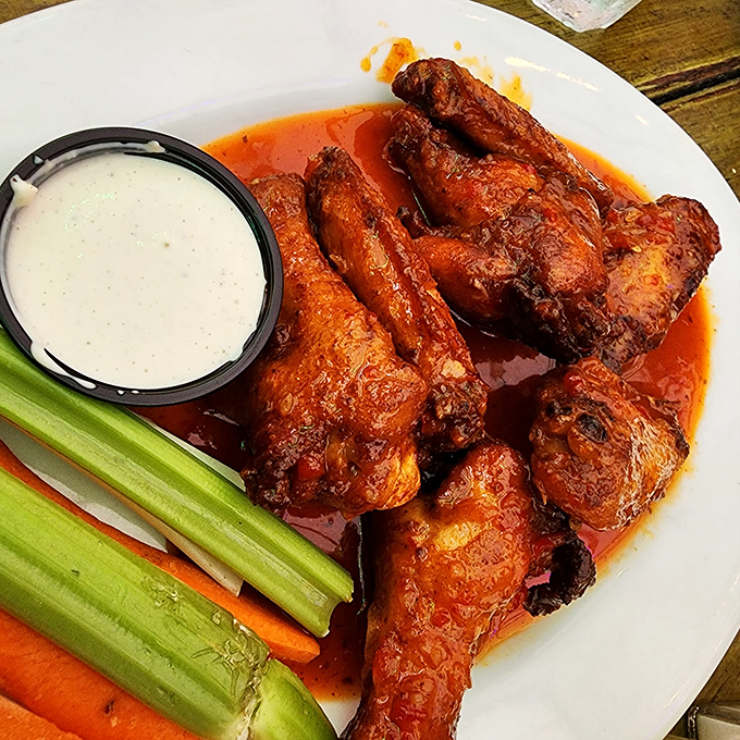 Buffalo wings done right: glistening with sauce, accompanied by cooling celery and carrots&mdash;proof that sometimes the classics need no improvement.