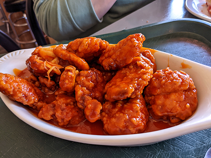 Buffalo wings so vibrant they practically glow, swimming in sauce that promises to be the perfect dance partner for cold beer.