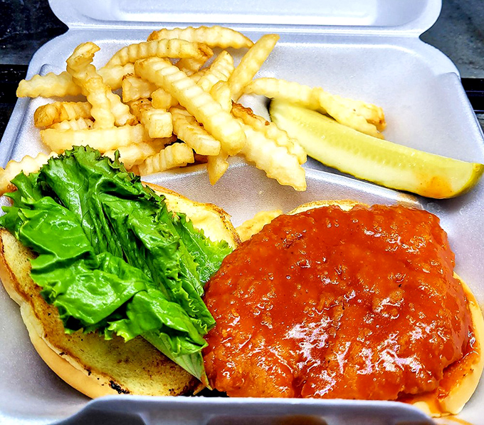 A buffalo chicken sandwich that brings the heat, served with crinkle-cut fries that provide the perfect cooling counterpoint to each spicy bite.