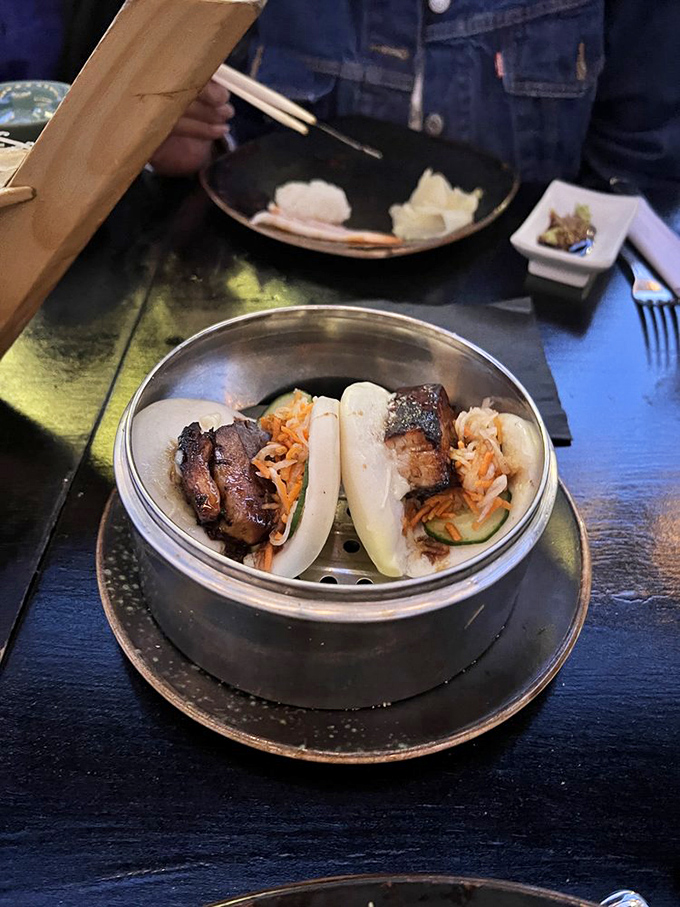 These steamed buns cradle perfectly caramelized pork belly like tiny edible hammocks designed for flavor naps.