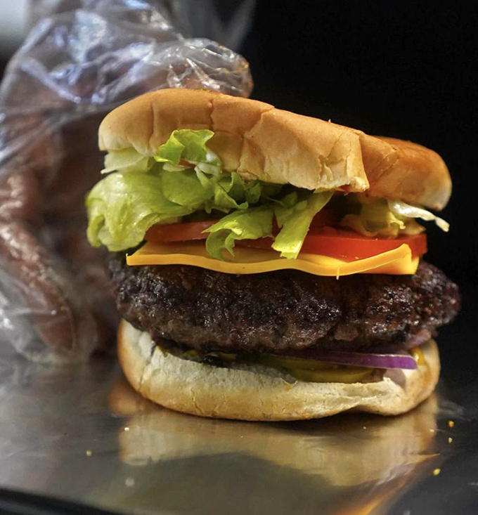Architectural perfection – layers of fresh veggies, melted cheese, and a patty that's been kissed by the grill gods themselves.