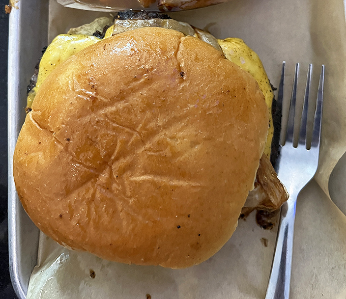 This isn't just a burger; it's a hand-held masterpiece on a brioche throne, waiting to make your day significantly better.