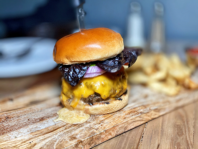 This isn't just a burger&mdash;it's a masterclass in balance. Melted cheese cascading down beef, crowned with caramelized onions on a perfectly toasted bun.