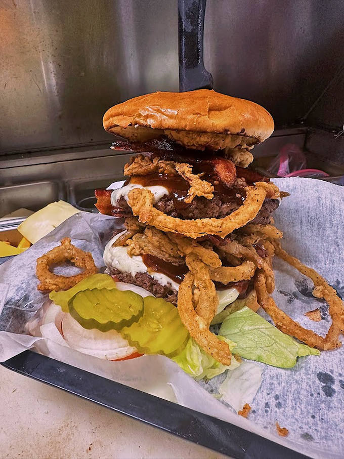 This isn't just a burger&mdash;it's an architectural marvel of crispy onion rings, bacon, and beef that requires both hands and possibly a building permit.