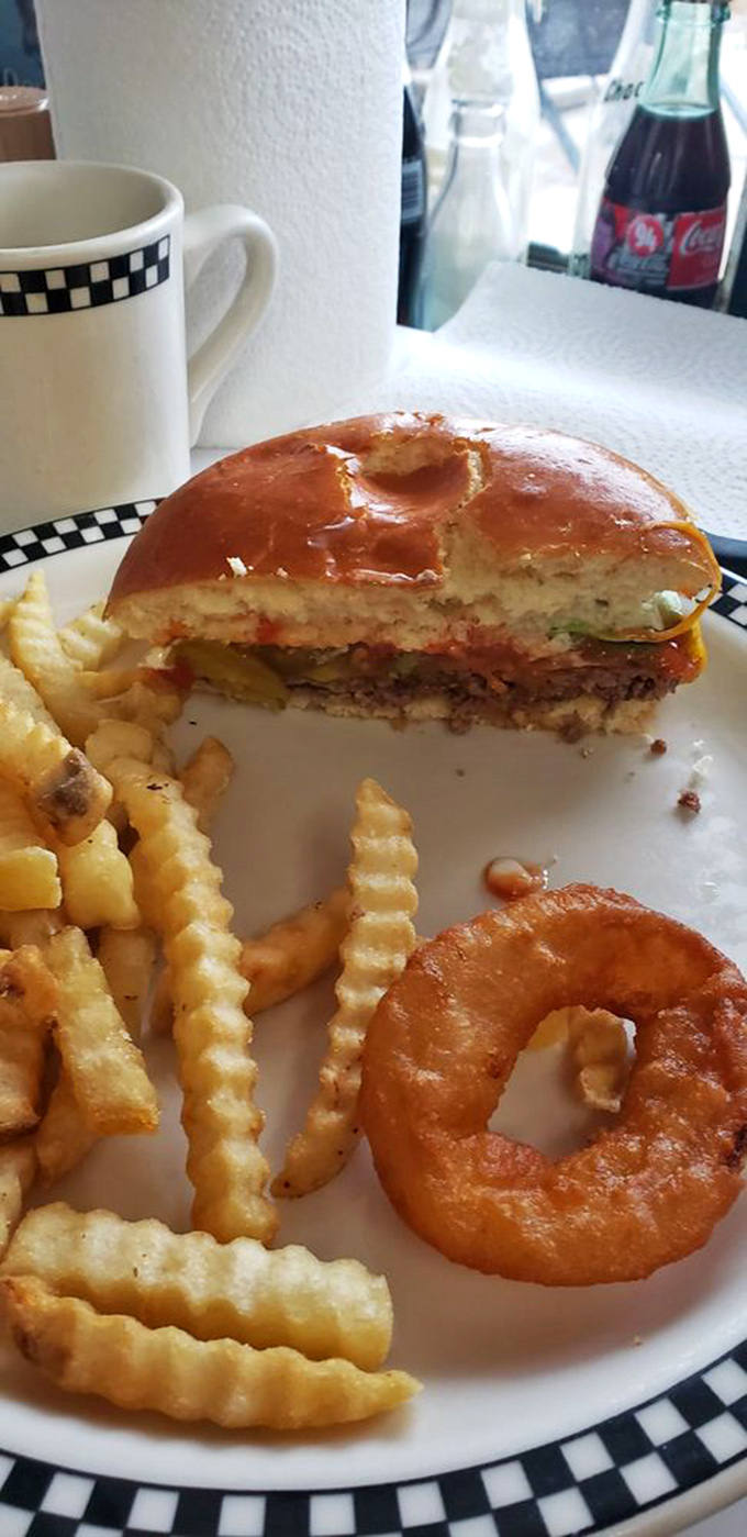 Half-eaten burger evidence: the true sign of deliciousness is when you're too excited to remember to take the photo before diving in. Those crinkle-cut fries aren't just sidekicks.