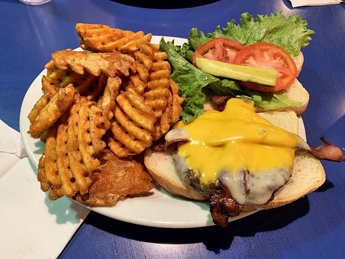 Even lunch gets the royal treatment – this burger with waffle fries proves the kitchen knows more than just breakfast choreography.