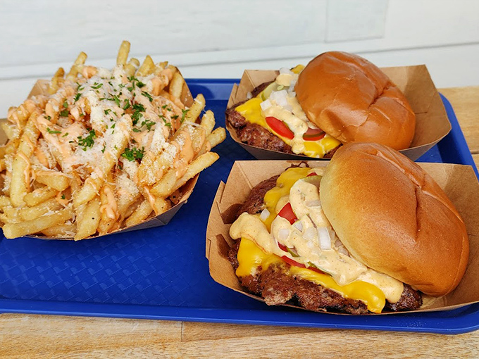 Comfort food gets the gourmet treatment with these perfectly crafted burgers and golden fries&mdash;proof that sometimes happiness comes on a blue plastic tray.