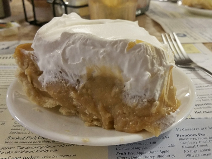 Butterscotch pie reaching for the heavens with its towering meringue &ndash; proof that sometimes the best things in life are simple, sweet, and slightly excessive.