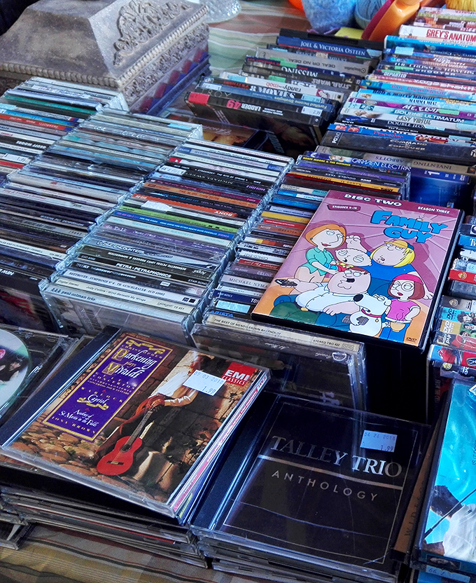 A time machine disguised as a DVD collection. Spot a Family Guy box set nestled among music CDs&mdash;physical media lives on in this digital age.