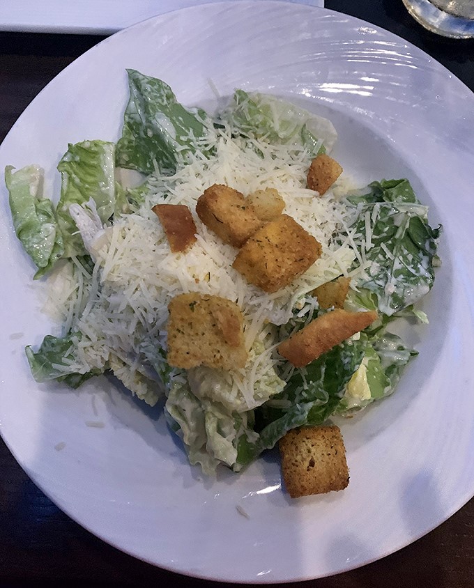 Caesar salad with generous parmesan and golden croutons&mdash;because even carnivores need their greens before the main event.