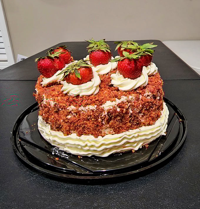 A red velvet cake crowned with fresh strawberries that would make even the most sophisticated pastry chef tip their toque in respect to small-town baking prowess.