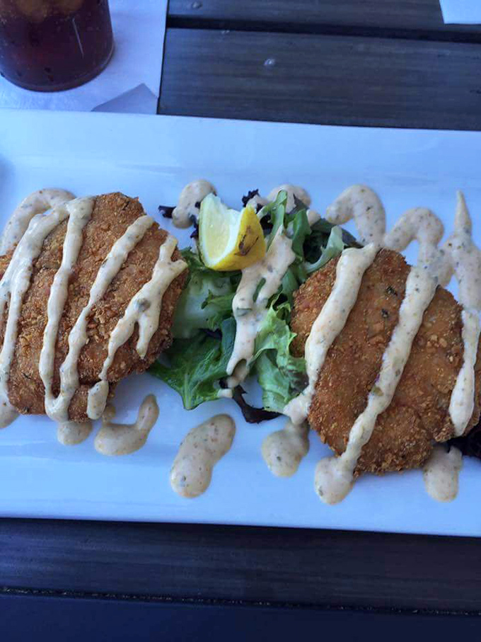 Those crab cakes aren't hiding behind excessive filler &ndash; just pure crabmeat with a golden crust and a drizzle of remoulade. Perfection.