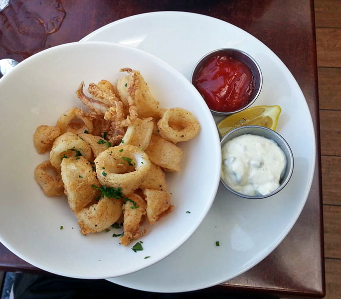 Calamari that's actually tender! These golden rings avoid the rubber-band texture that haunts lesser versions, served with classic cocktail and tartar sauces.