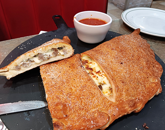 Not quite a pizza, not quite a sandwich—this calzone is the delicious identity crisis you'll want to help solve, one bite at a time.