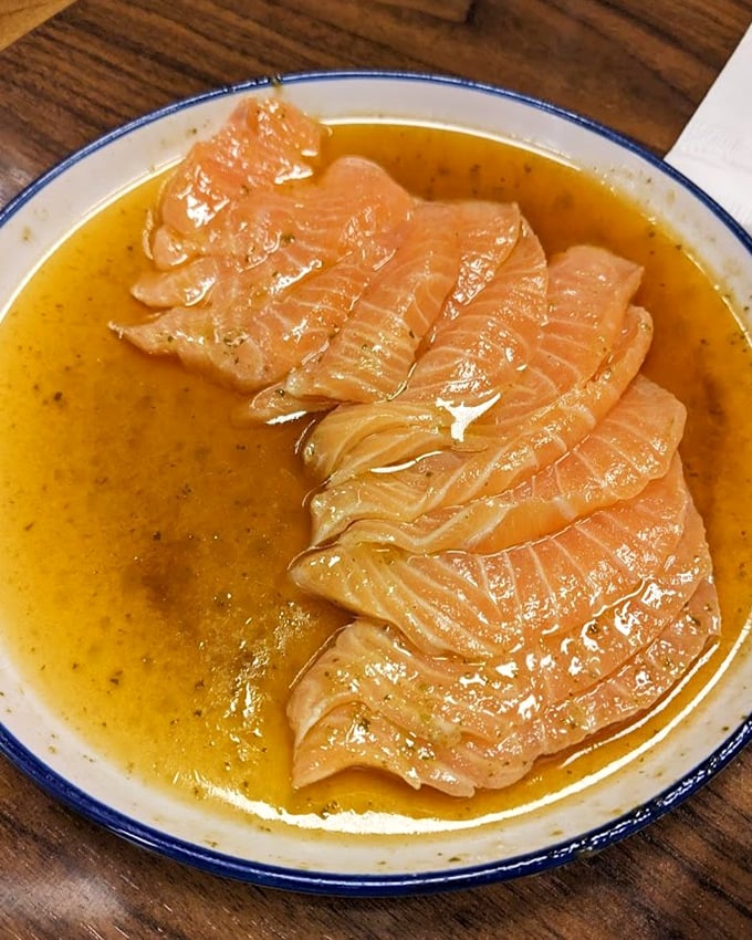 Carpaccio De Salm&atilde;o swimming in citrusy ponzu sauce &ndash; proof that sometimes the best cooking involves no heat at all.