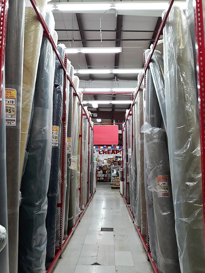 The carpet section: where room-sized remnants stand at attention like soldiers waiting to transform your home at a fraction of the cost.
